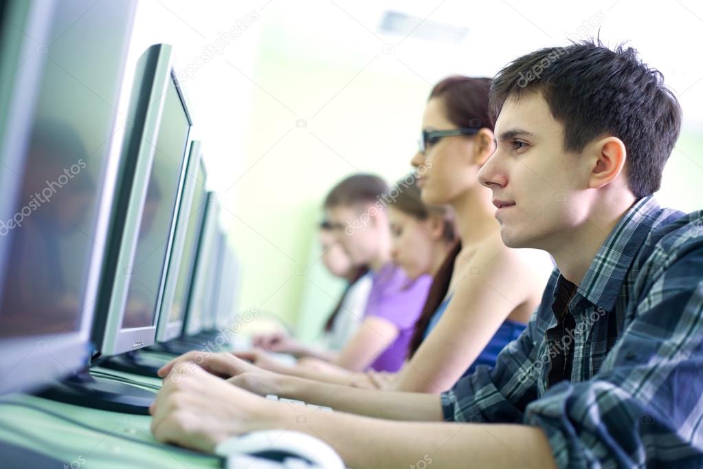 Teens in internet-cafe Stock Photo by ©yanlev 55958655