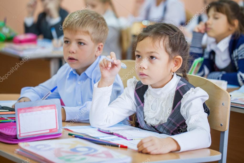 Schoolchildren sit in classroom Stock Photo by ©yanlev 83596628