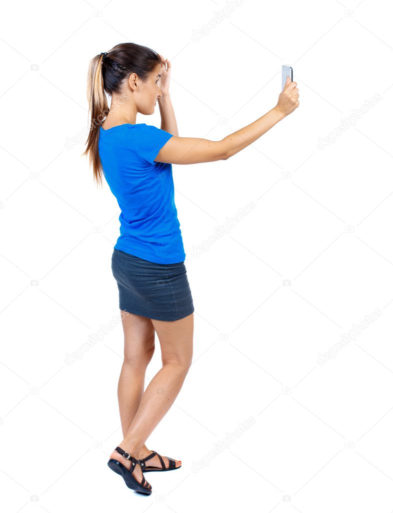 Back view of standing young beautiful woman using a mobile pho Stock ...