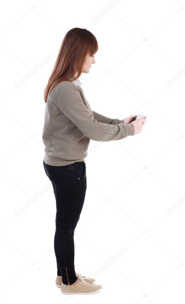 Back view of standing young beautiful woman using a mobile pho Stock ...