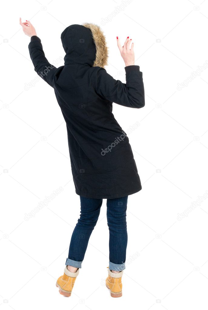 Back view woman in winter jacket Balances waving his arms. Stock Photo ...