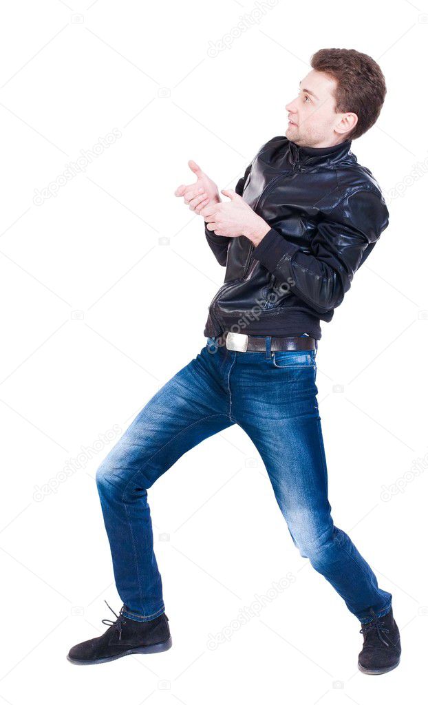 Back view of standing man pulling a rope from the top or cling t Stock ...