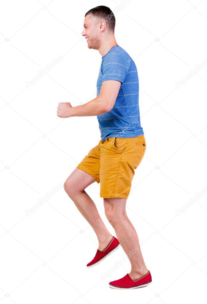 Back view of running man in t-shirt and shorts Stock Photo by ...