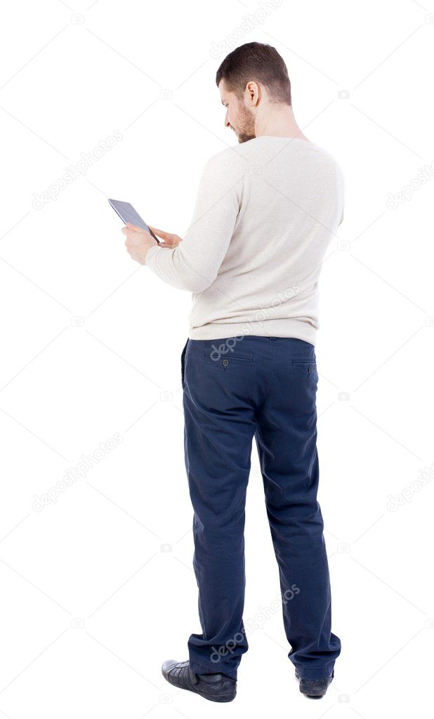 Back view of standing young man with tablet computer in the hand Stock ...