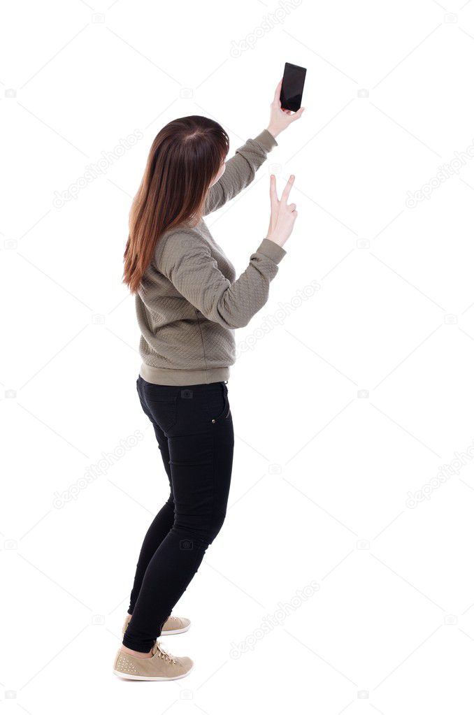 Back view of standing young beautiful woman using a mobile pho — Stock ...