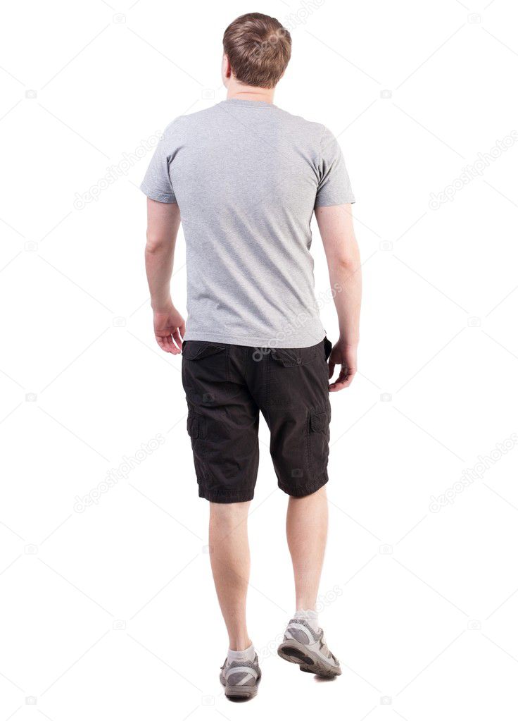 Back view of walking handsome man in shorts and sneakers Stock Photo by ...