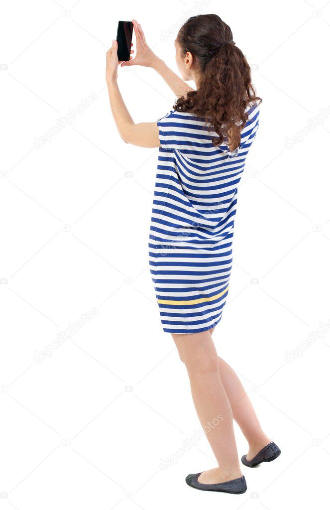 Back view of standing young beautiful woman using a mobile pho Stock ...