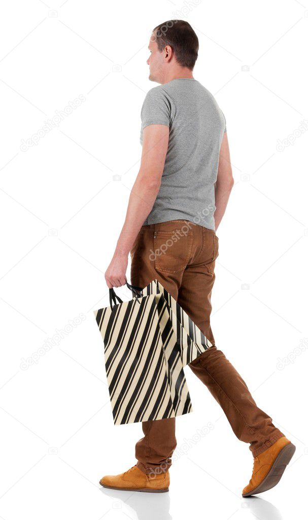 Back view of going handsome man with shopping bags. Stock Photo by ...