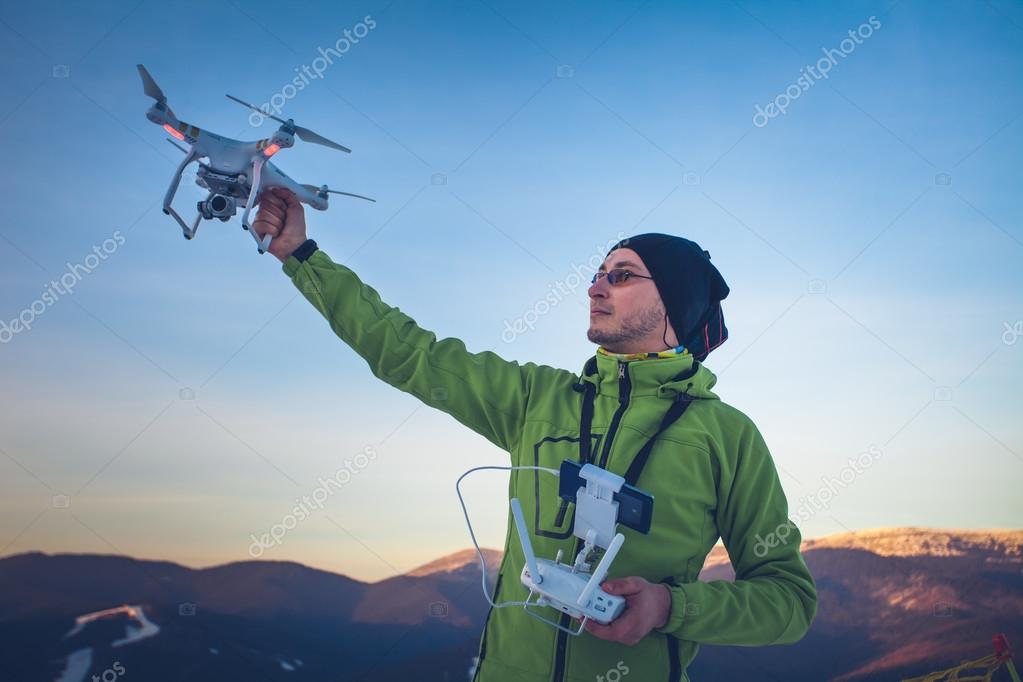 Man holding drone and remote control Stock Photo by ©goinyk 124166248