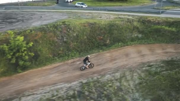 Aerial man riding bike at traffic road. Summer nature landscape ...