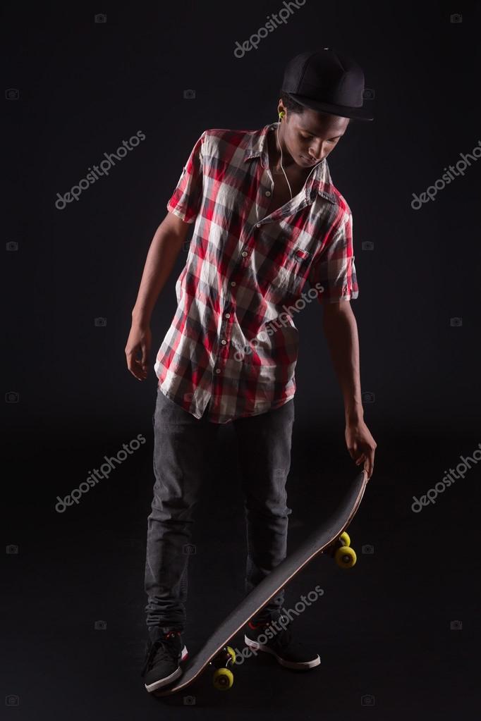 Skater boy posing with skateboard — Stock Photo © hsfelix #80162664