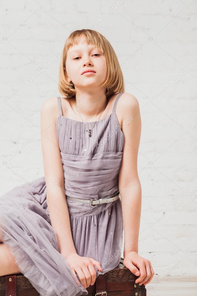 Beautiful girl sitting on chest Stock Photo by ©mamontenok 85229620