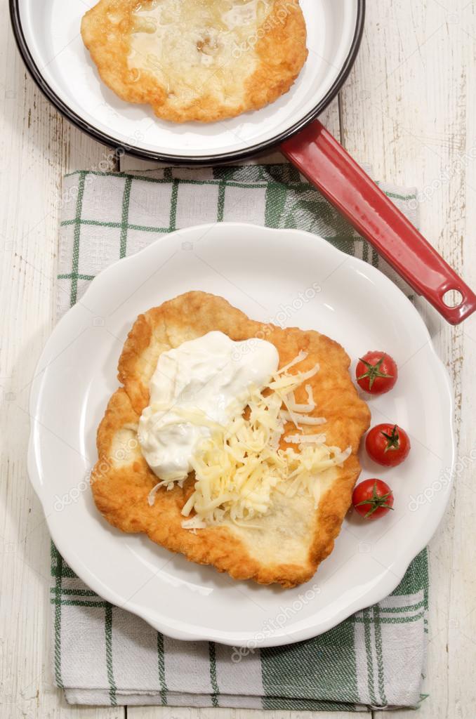 Hungarian langos with sour cream and cheese Stock Photo by ©Szakaly ...