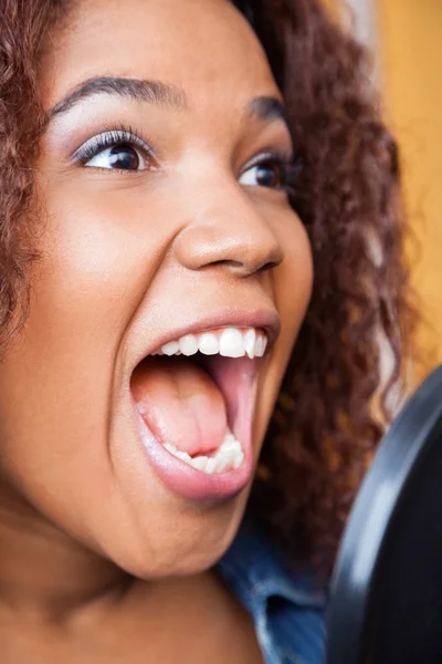 Female Singer With Mouth Open Performing In Recording Studio - Stock ...