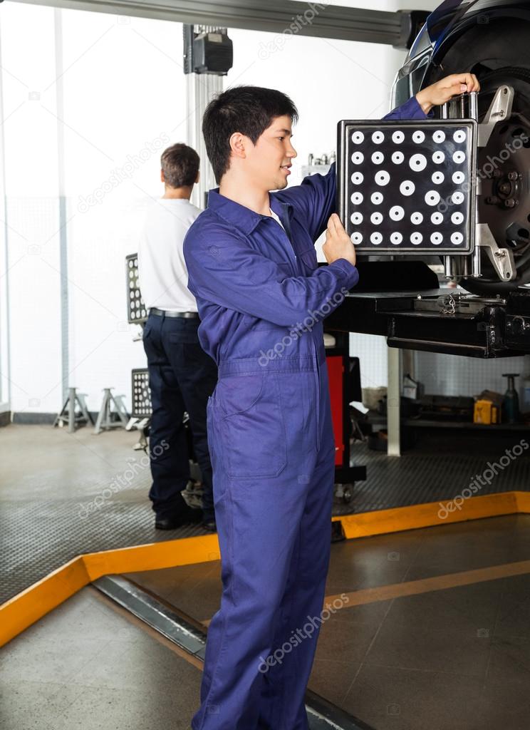 Mechanic Adjusting Alignment Machine On Car Stock Photo by ©SimpleFoto ...