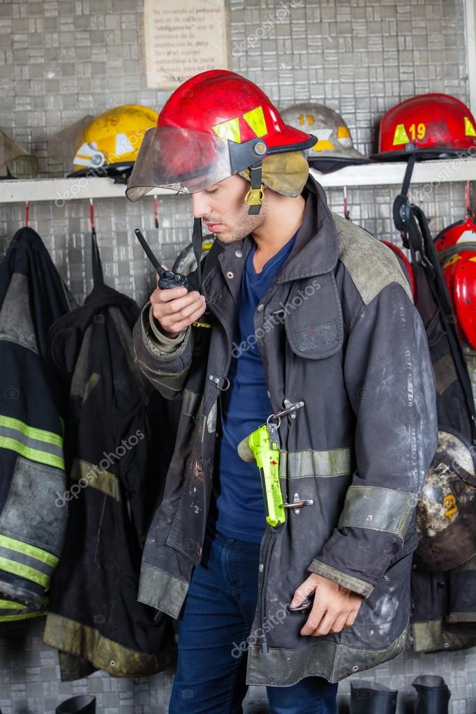 Firefighter Using Walkie Talkie In Fire Station Stock Photo by ...