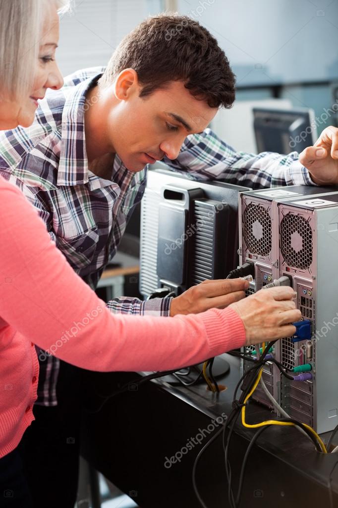 Tutor And Senior Student Setting Up Computer Stock Photo by ©SimpleFoto ...