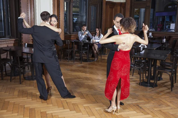 Passionate Dancers Performing Tango While Couple Dating In Resta Stock ...