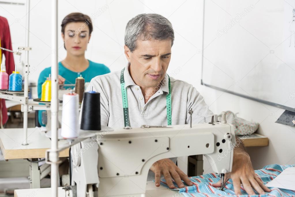 Tailor Using Sewing Machine In Factory Stock Photo by ©SimpleFoto 122473112