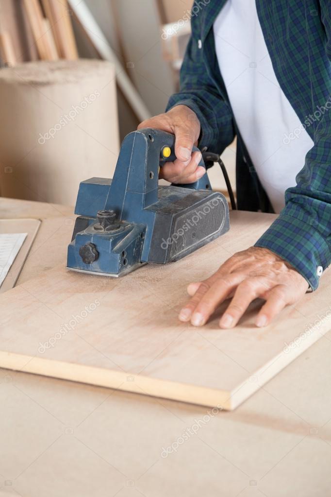 Carpenter Using Electric Planer On Wood Stock Photo by ©SimpleFoto 56244409