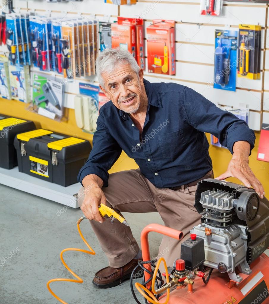 Confident Senior Man With Air Compressor In Store — Stock Photo ...