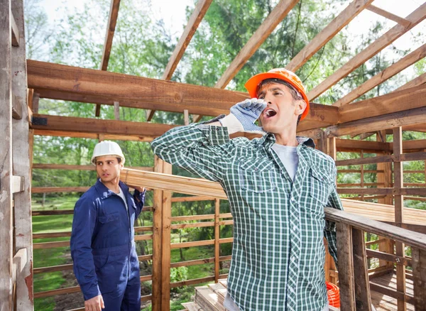 Construction Worker Screaming While Carrying Ladder At Site - Stock ...