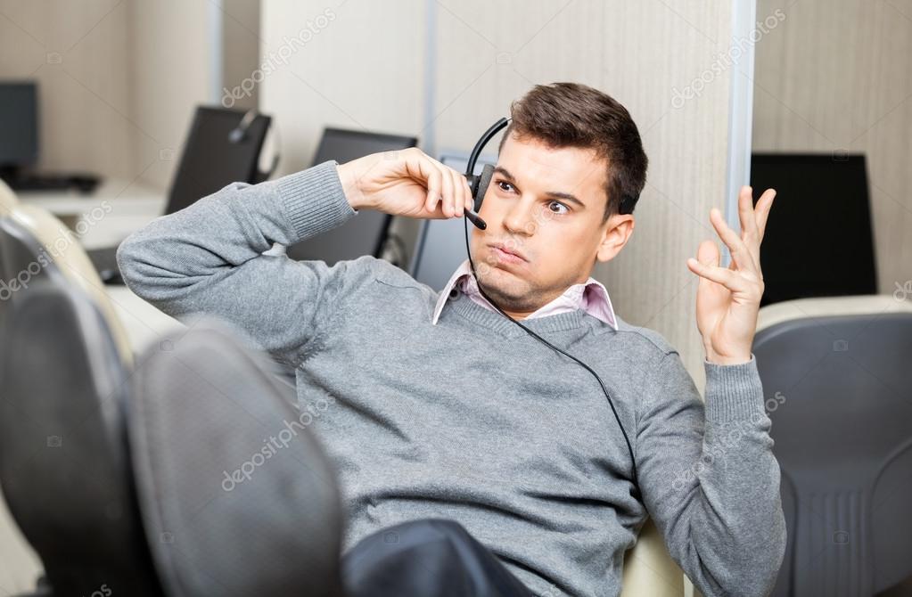 Angry Customer Service Representative Gesturing While Using Head Stock ...