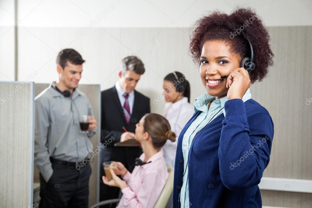 Smiling Female Customer Service Representative Holding Headphone ...