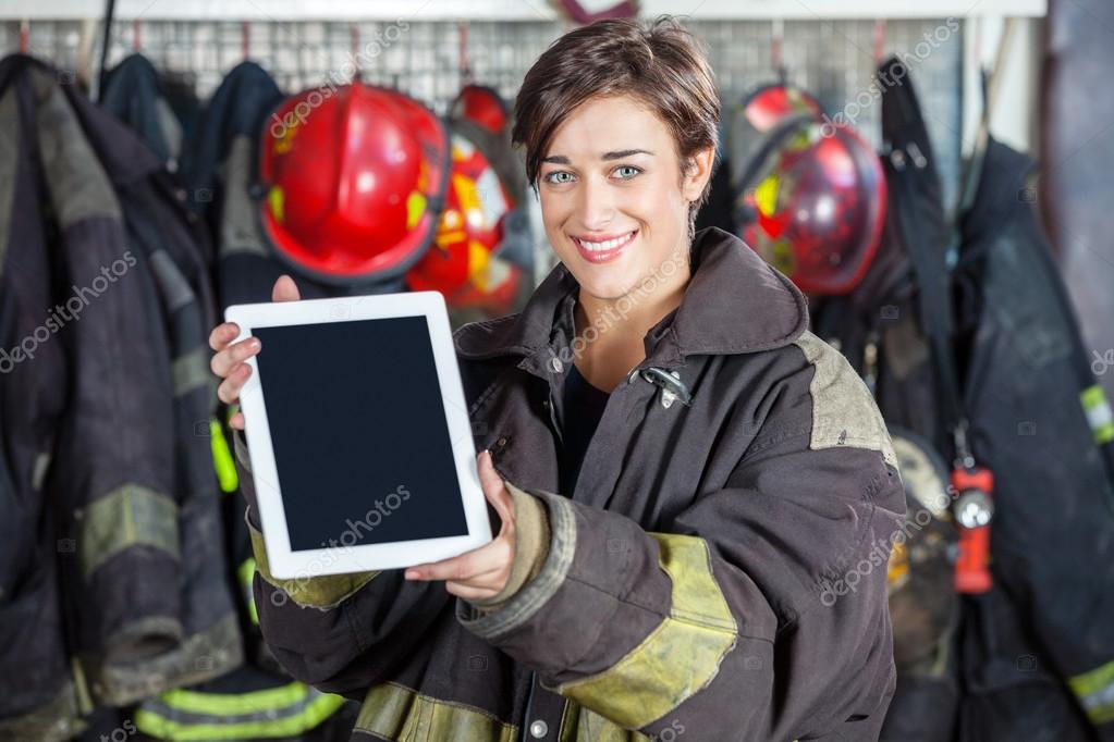 Beautiful Firewoman Showing Digital Tablet At Fire Station Stock Photo ...