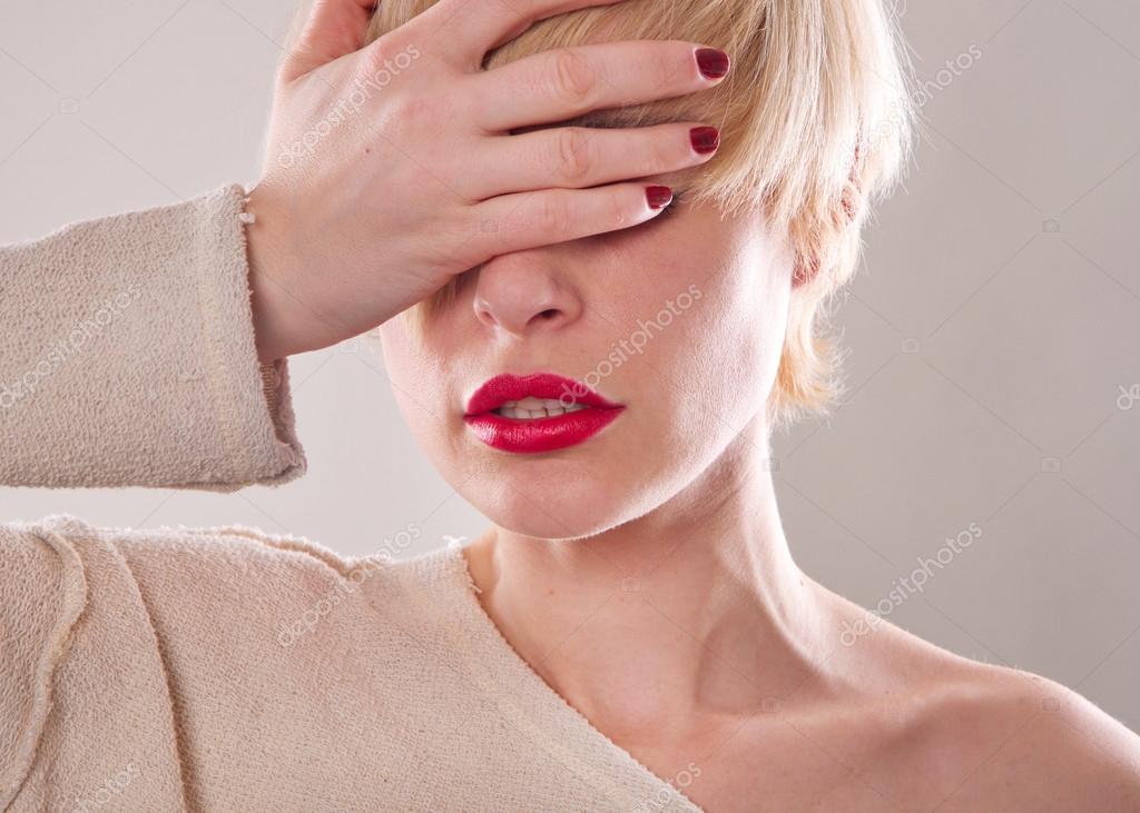 The blond woman with short hair and a beautiful smile with red lips ...