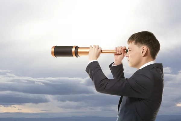 Businessman looks through a telescope - Stock Image - Everypixel