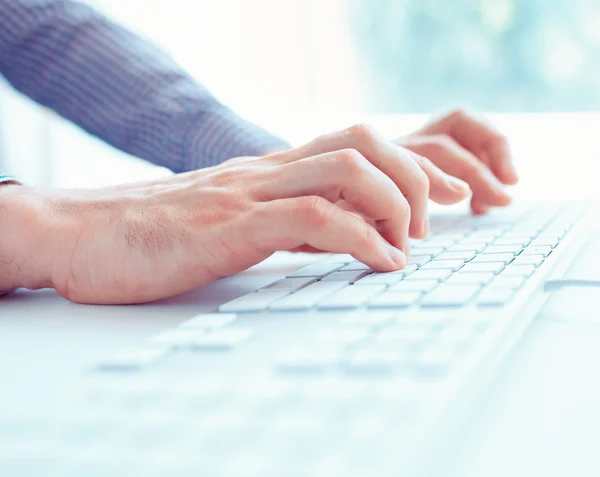 Male office worker typing on the keyboard - Stock Image - Everypixel