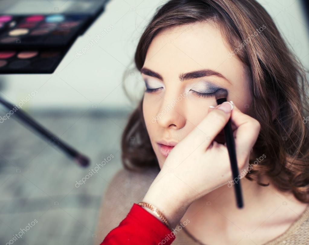 Woman applying makeup — Stock Photo © TatyanaGl #66196435