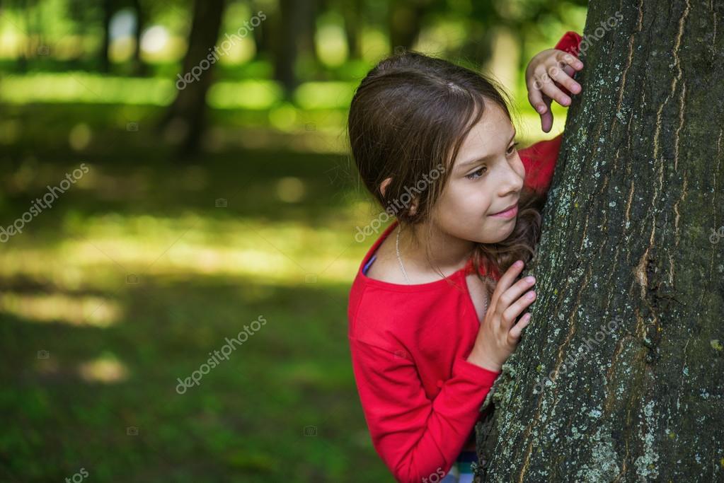 Little smiling girl hiding behind tree — Stock Photo © BestPhotoStudio ... Little smiling girl hiding behind tree — Stock Photo © BestPhotoStudio ...