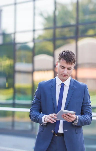 Young business man think look up hold tablet pc computer - Stock Image ...