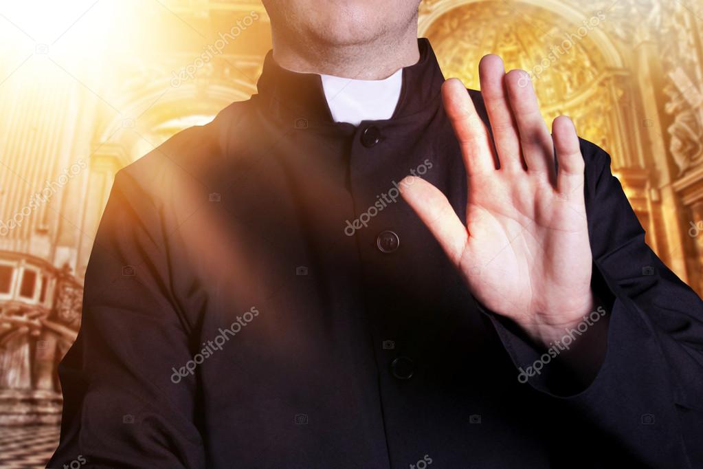 The priest at the church with raised hand Stock Photo by ©ambrozinio ...
