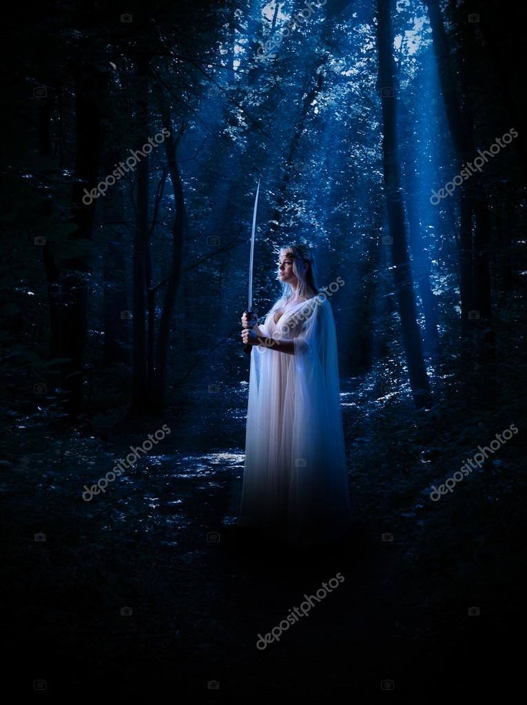 Elven girl with sword in night forest Stock Photo by ©rbvrbv 89128144