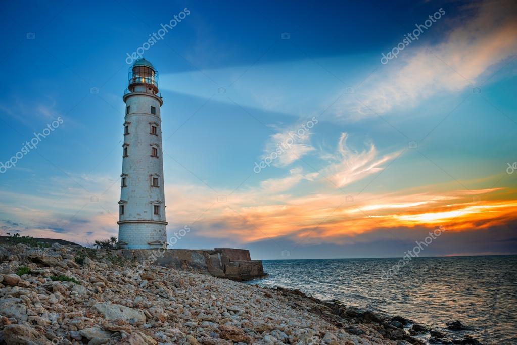 Lighthouse searchlight beam through sea — Stock Photo © dovapi #75187793