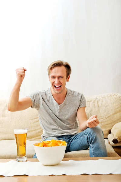 Angry man screaming while watching sports on tv - Stock Image - Everypixel