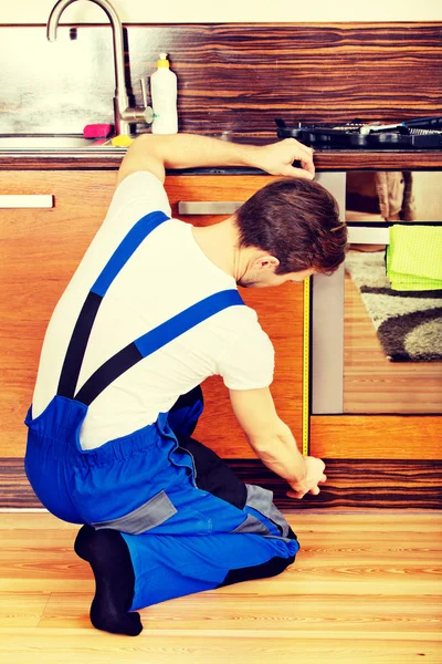 Young man repair something inside kitchen cabinet under the sink Stock ...