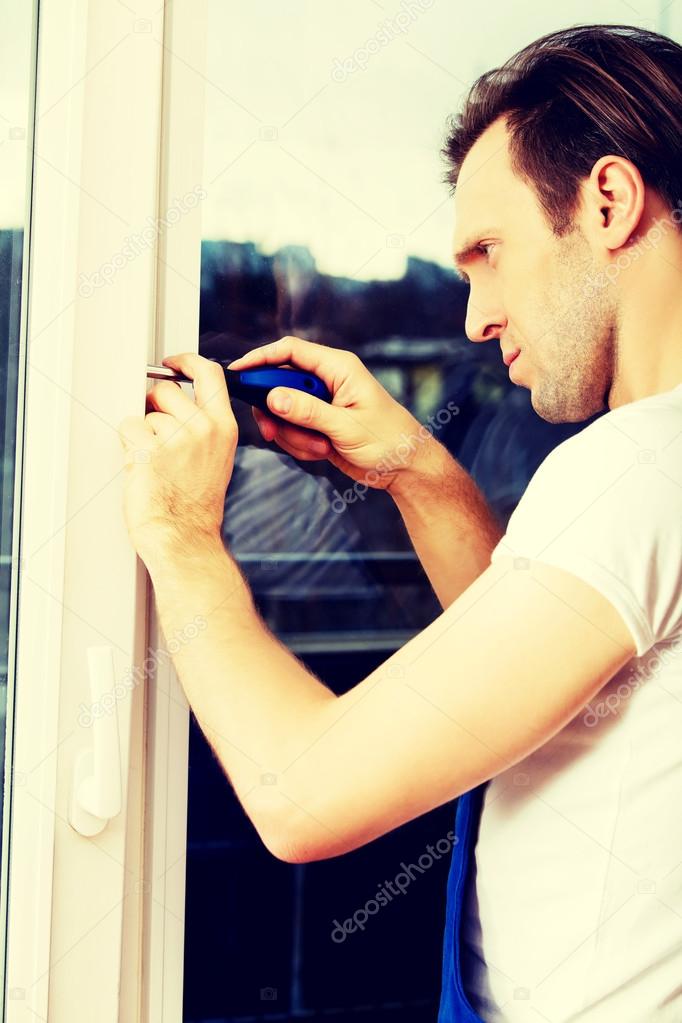Young handyman repair window with screwdriver Stock Photo by ©piotr ...