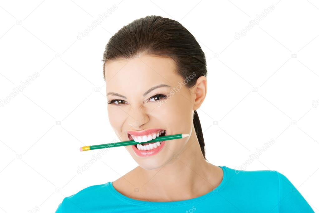Woman biting her pencil Stock Photo by ©piotr_marcinski 58580123