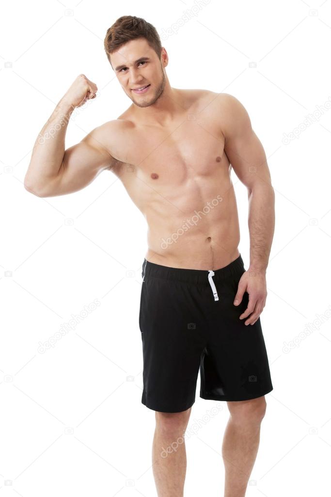 Athletic man showing his muscles. — Stock Photo © piotr_marcinski #64707691