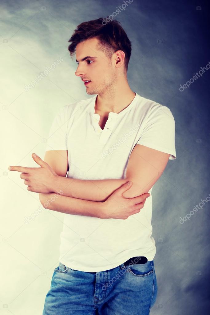 Handsome man pointing to the left. Stock Photo by ©piotr_marcinski 93551766