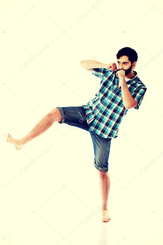 Young casual man kicking. — Stock Photo © piotr_marcinski #96455858