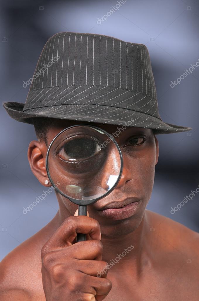 Black Man Looking Through Magnifying Glass