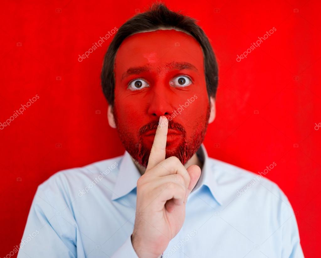 Young man portait with red painted face Stock Photo by ©zurijeta 98591724