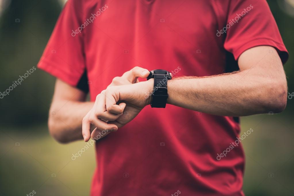 Runner training and using stopwatch with heart rate monitor — Stock ...