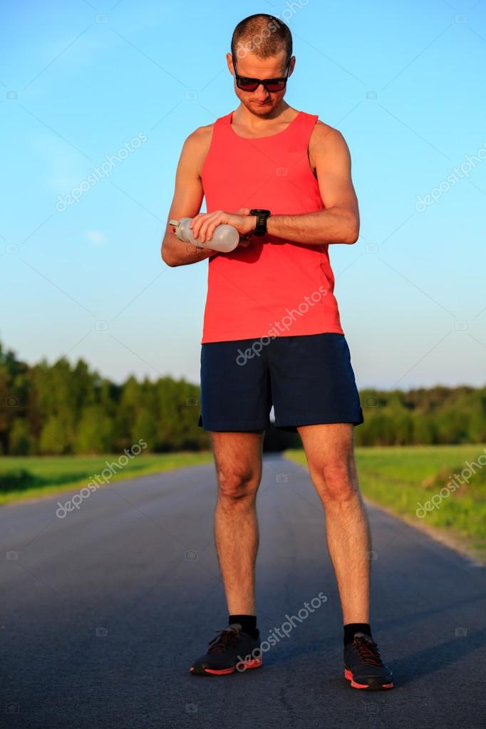 Runner training and checking stopwatch smart watch, cross countr ...