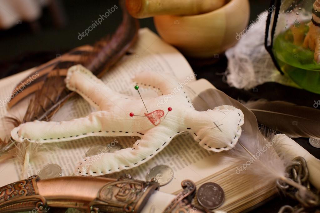 Voodoo gypsy putting needles in a doll — Stock Photo © Forewer #65550725